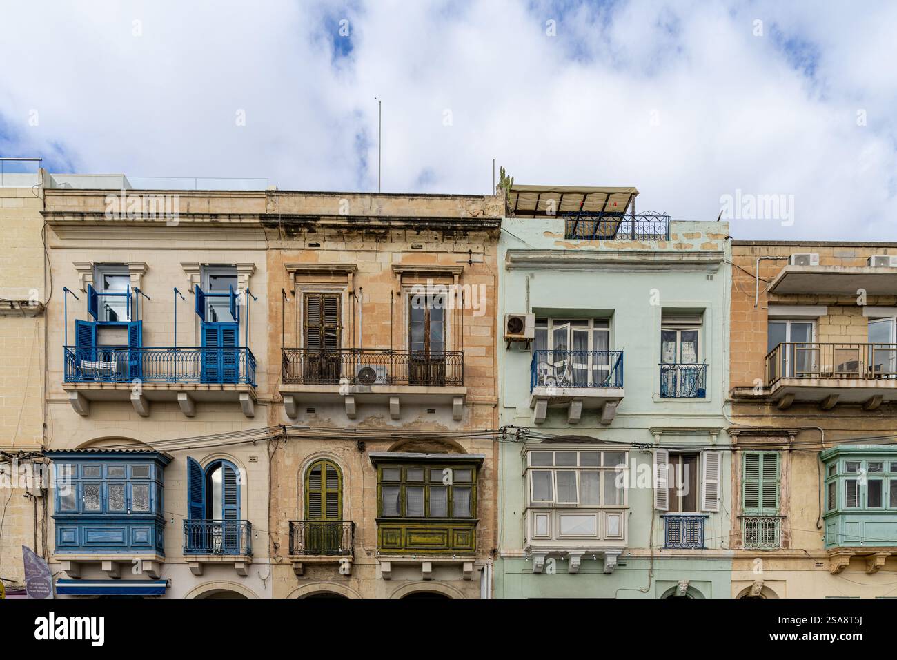 Traditional house detail in Malta. Limestone yellow bricks and colorful ...