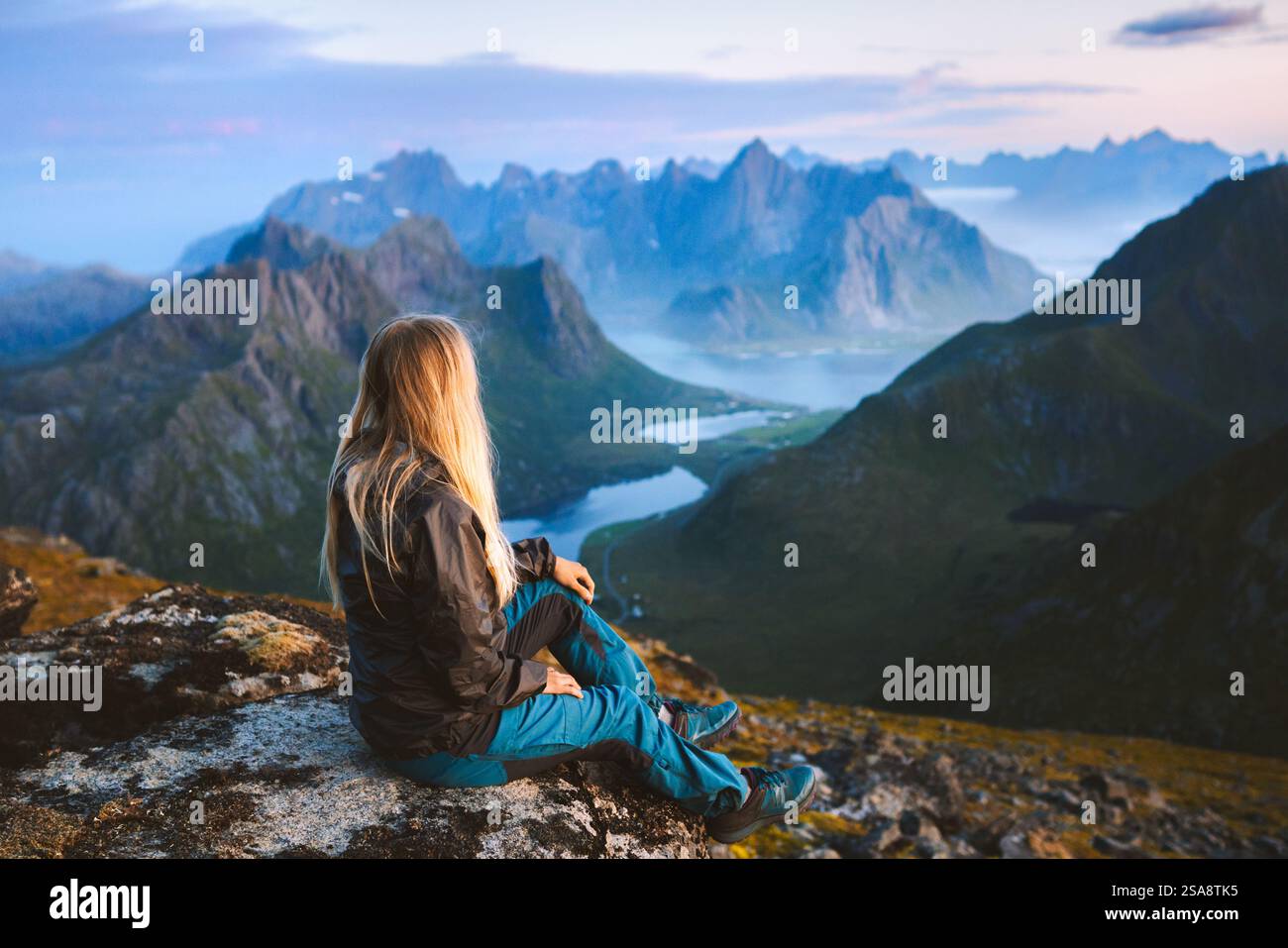 Solo traveler enjoying landscape in Norway Lofoten islands aerial view ...