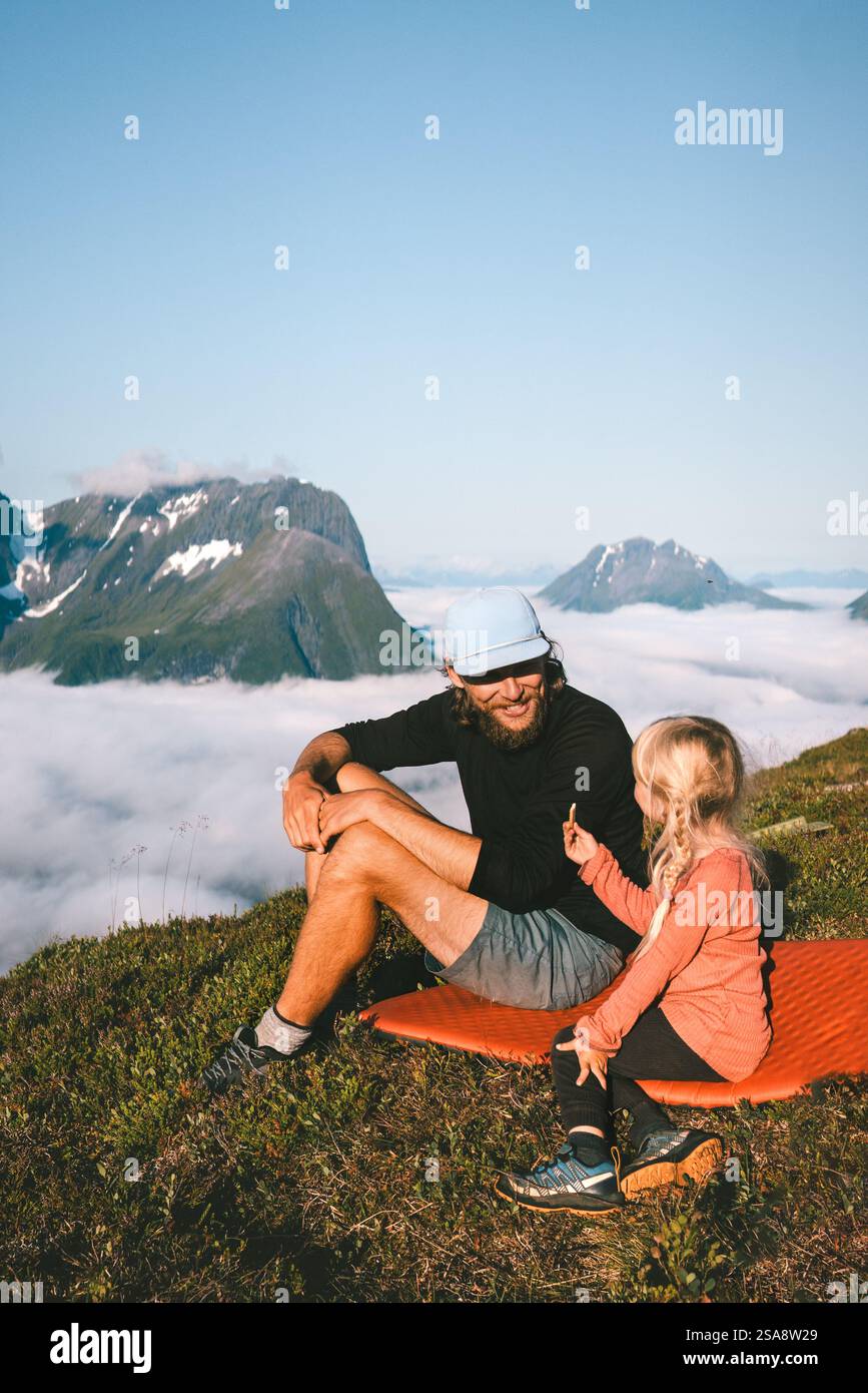 Family father and child hiking in mountains together travel active ...