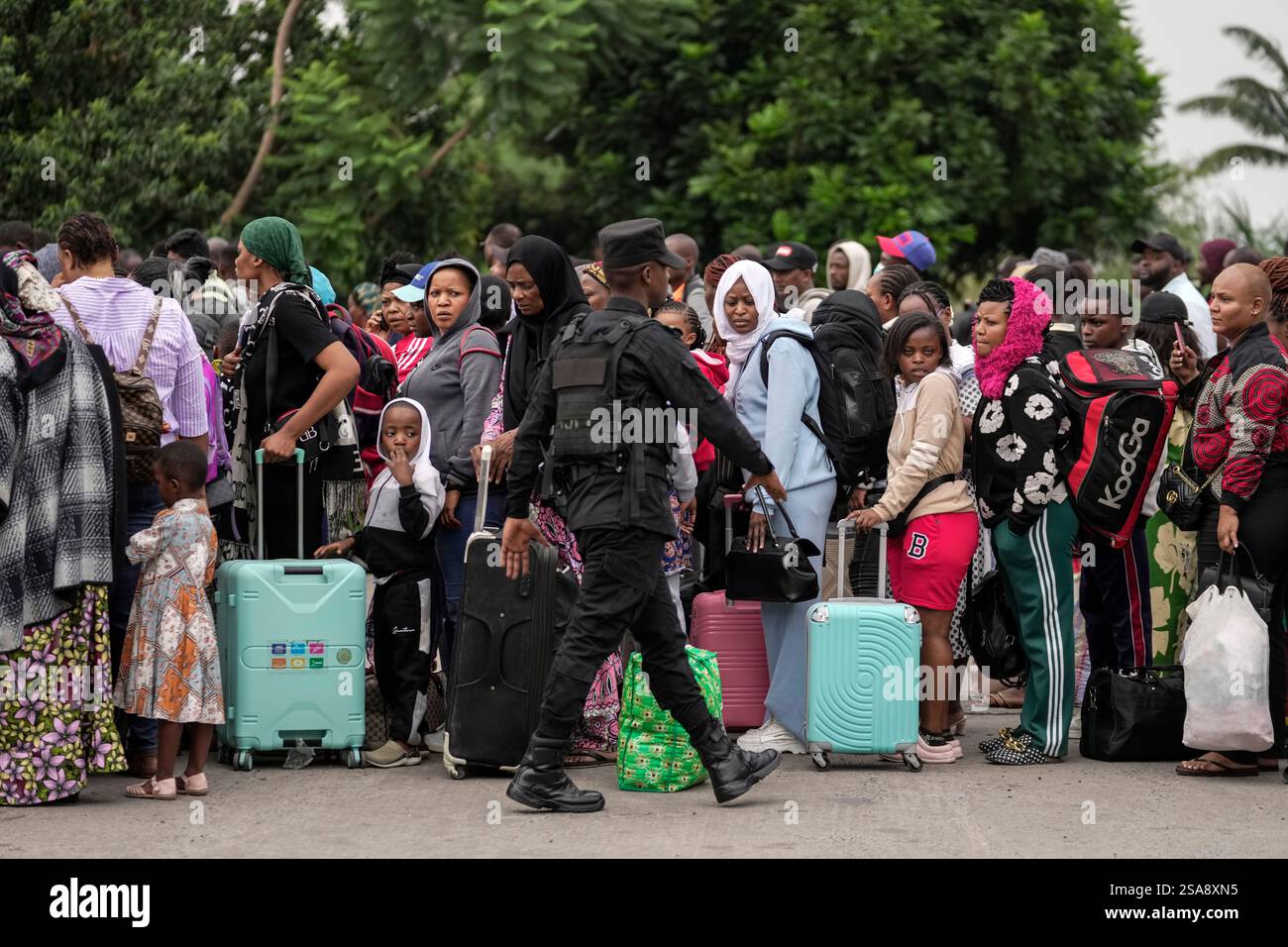 Rwanda security officials check people crossing from Congo in Gisenyi, Rwanda, Wednesday, Jan ...