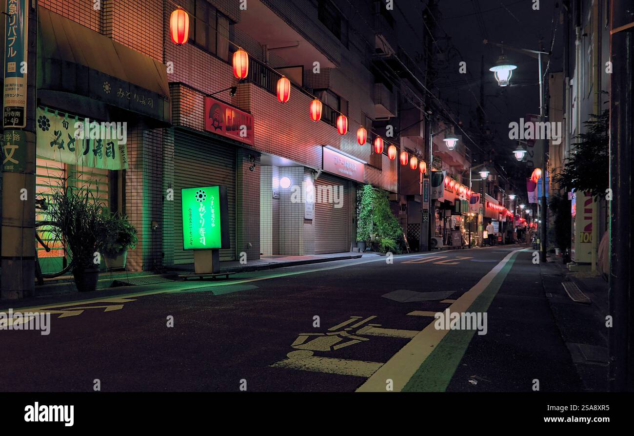 Night view of a mostly empty street near Koenji Station in western ...