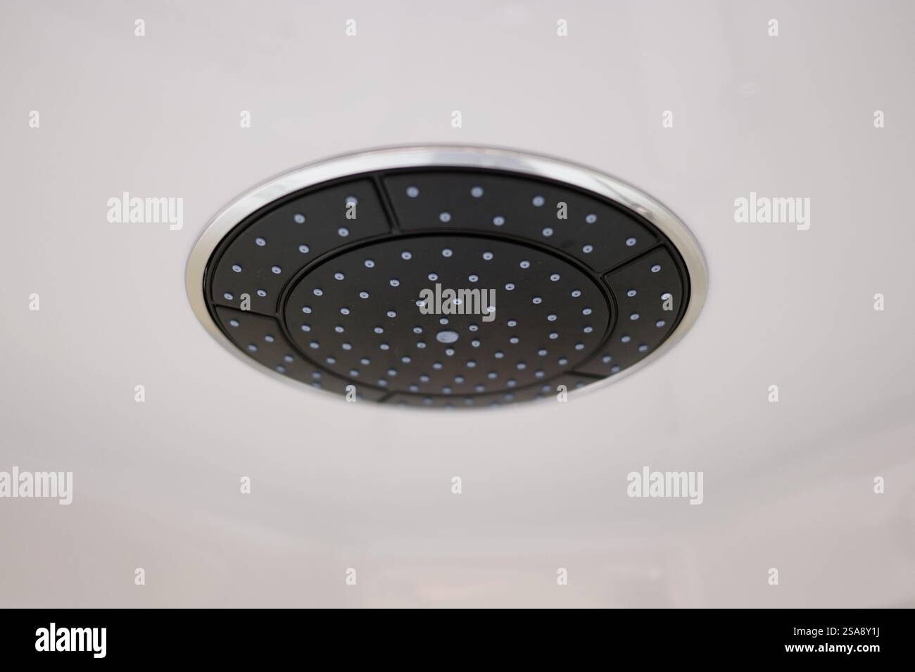 Modern round chrome shower head in a bathroom, close-up. Concept of ...
