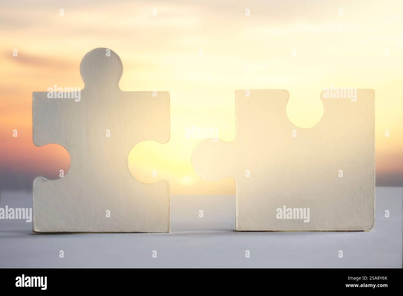 puzzle silhouettes approaching sunset; metaphor of love Stock Photo - Alamy