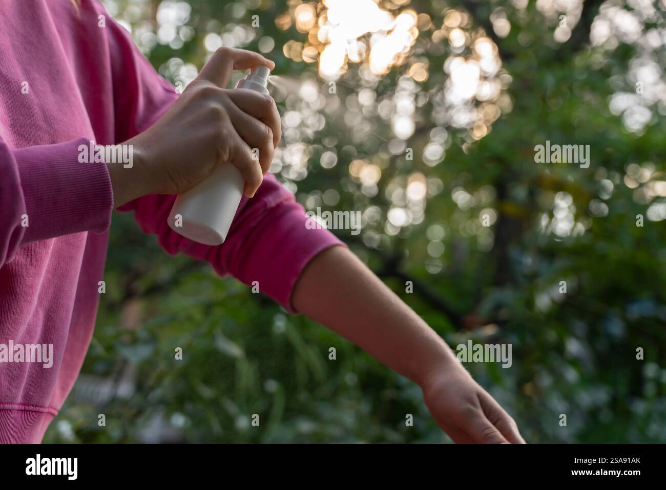 Hand applying insect repellent mosquito insecticide spray to kill flies ...