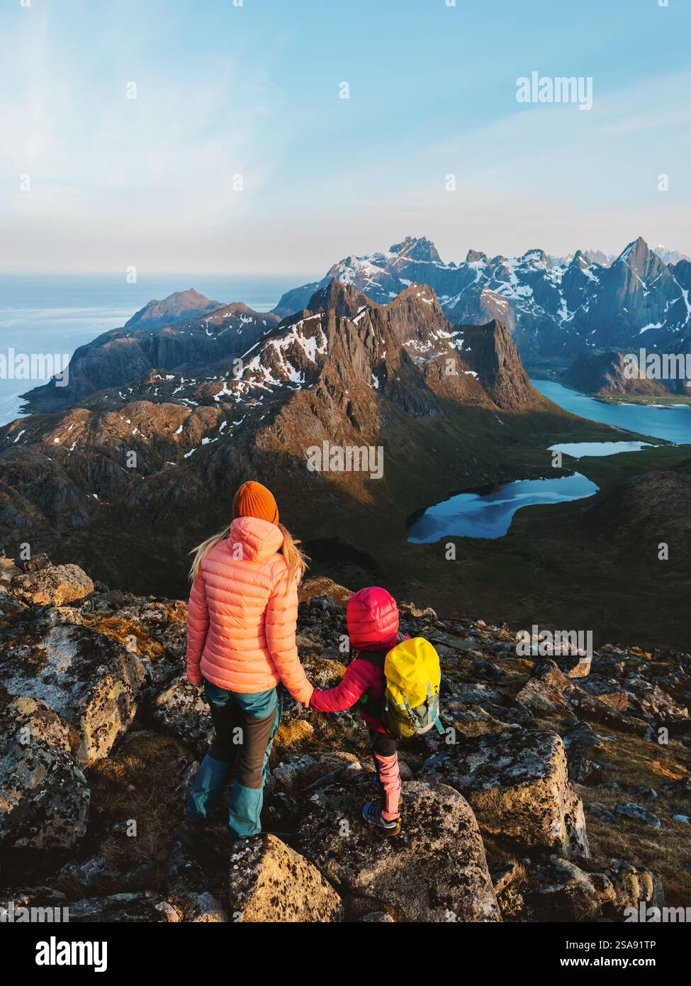 Mother and child hiking in Lofoten islands mountains family travel in ...