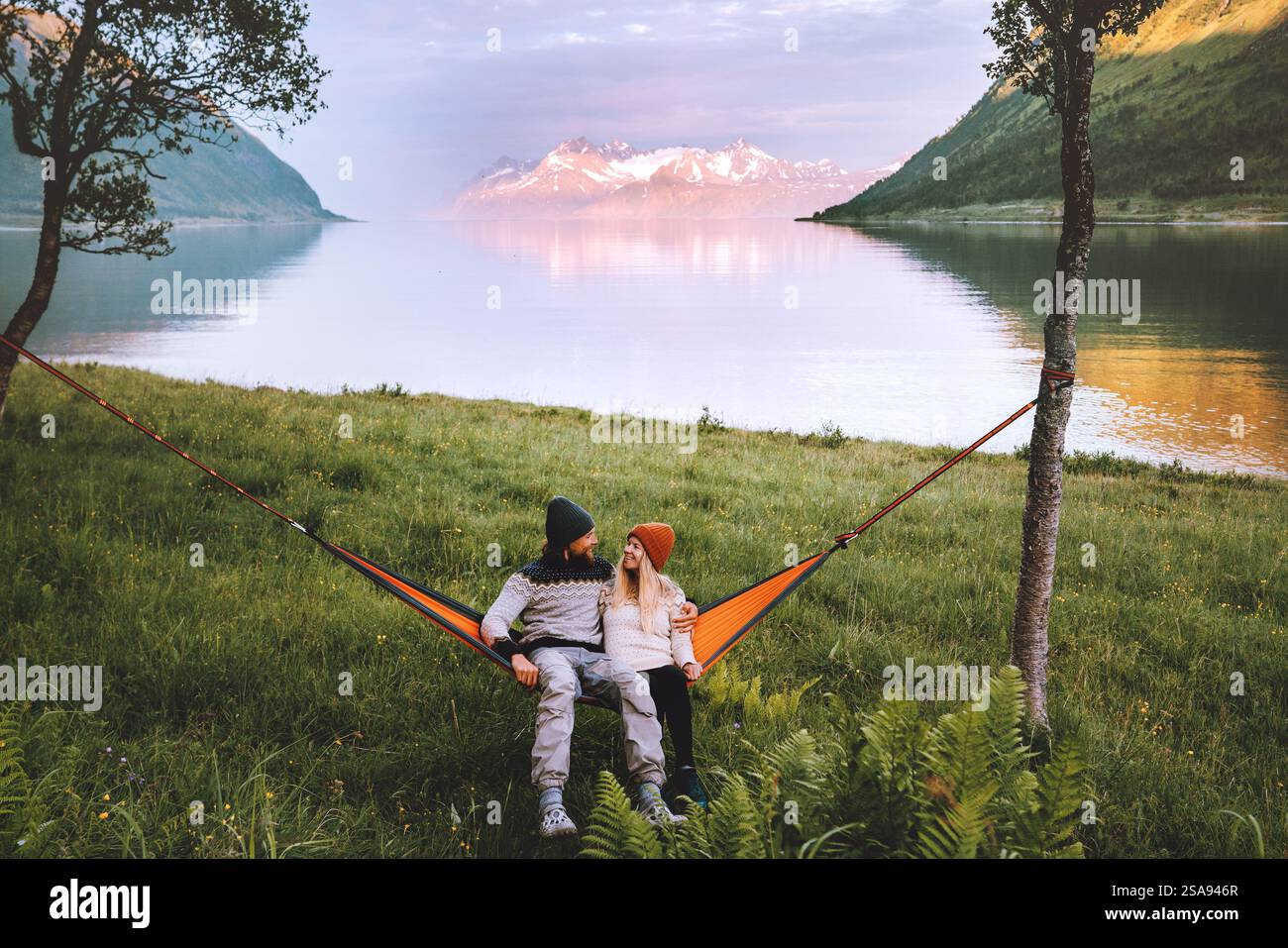 Couple friends chilling in hammock together man and woman traveling ...
