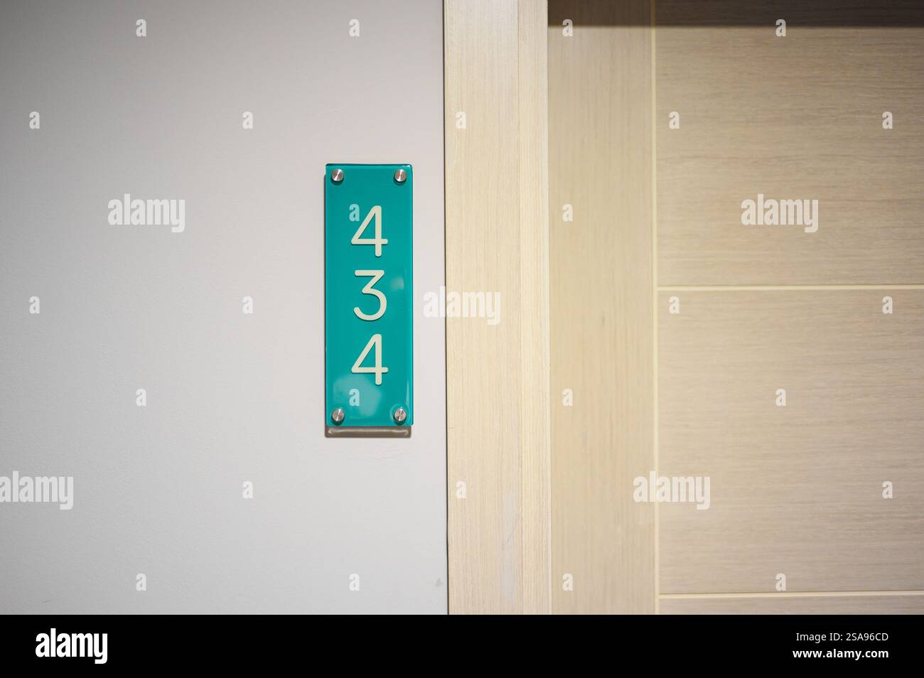 Sign with number on wall of hotel. Number 434, sign in hotel, hostel ...