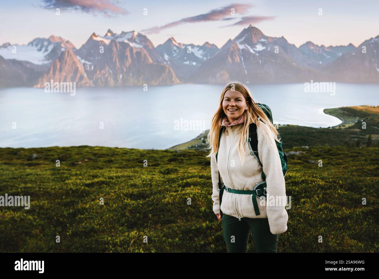 Woman hiking with backpack solo traveling tourist outdoor in Norway ...
