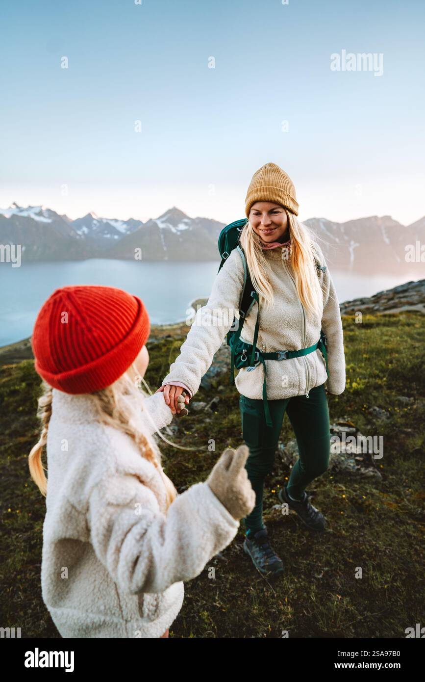 Child following mother holding hands while hiking in Norway on family ...