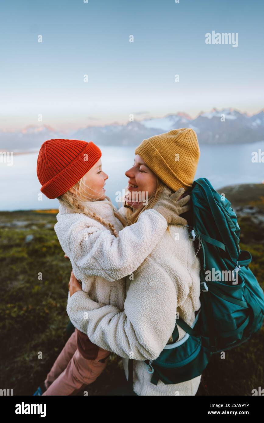 Mother hugging daughter child family hiking together travel outdoor active vacations in ...