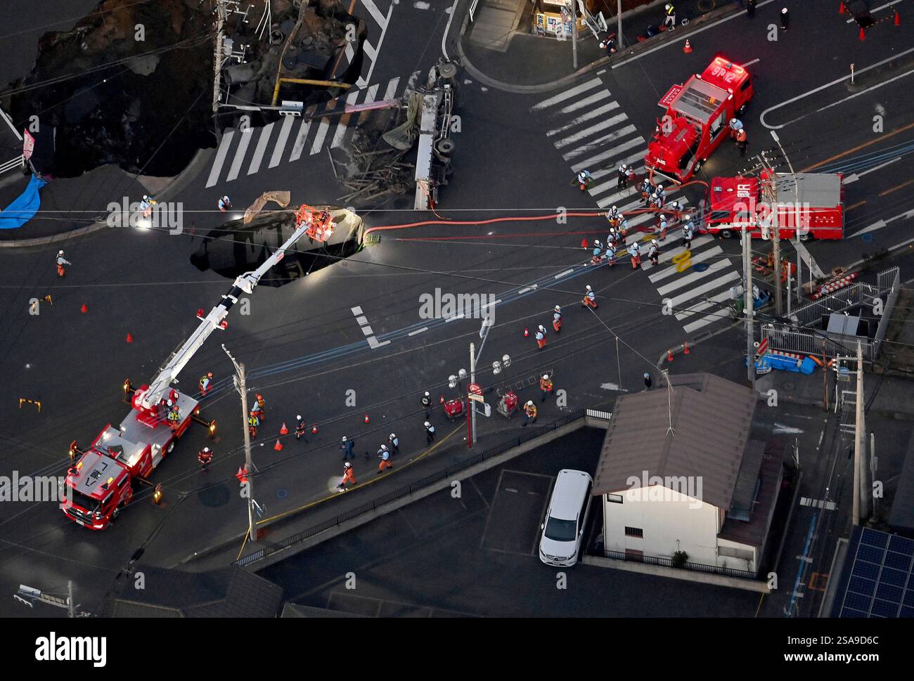 An aerial photo shows sinkholes at an intersection in Yashio City ...