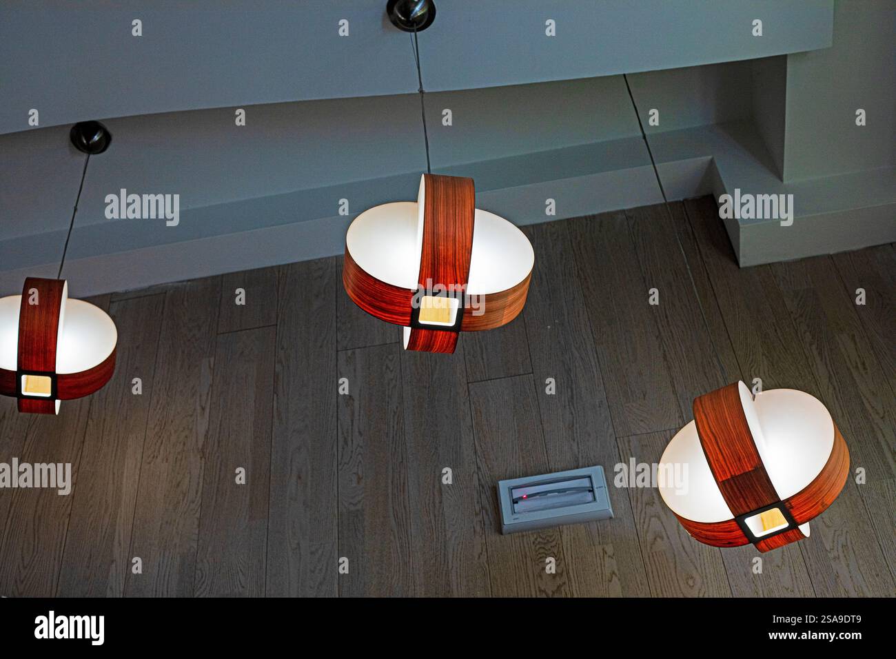 stylishceiling lamps with elements of wood and glass in a fast food ...