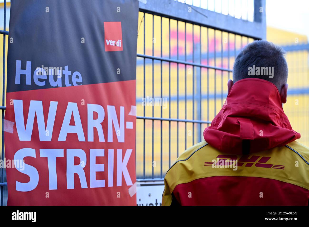 Duesseldorf, Germany. 29th Jan, 2025. A DHL employee stands at the ...