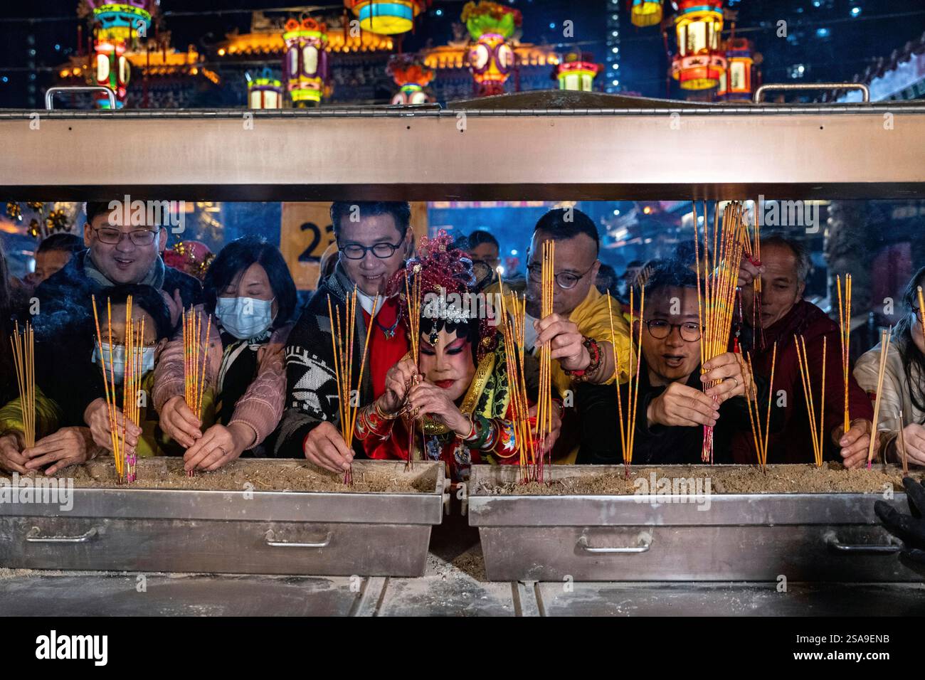 Actor Lana Wong Wai Lin, center, and other worshipers burn incense at ...