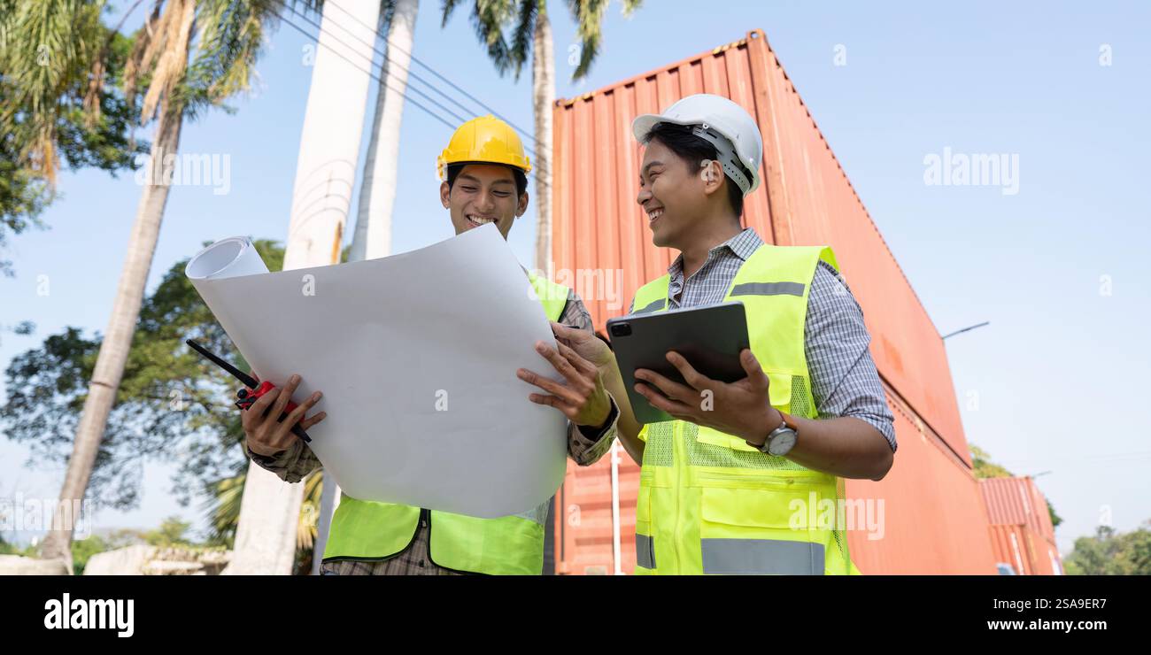 Engineers reviewing logistics plans and blueprints at a shipping ...