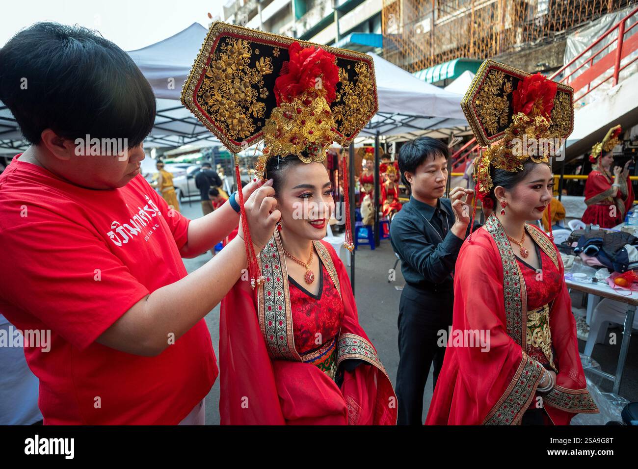 Thai performers are getting ready in traditional Chinese attire before ...
