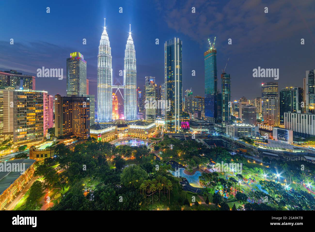 The KLCC Park and the Petronas Twin Towers at night Stock Photo - Alamy