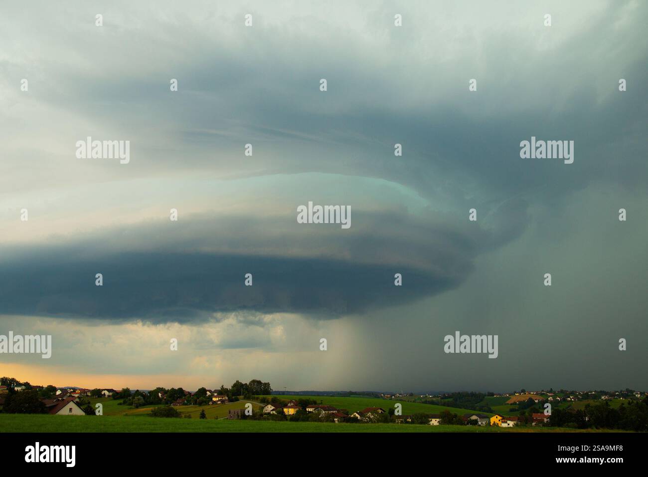 A huge, dark shelf cloud or Cumulonimbus (Cb) drifts across the meadow ...