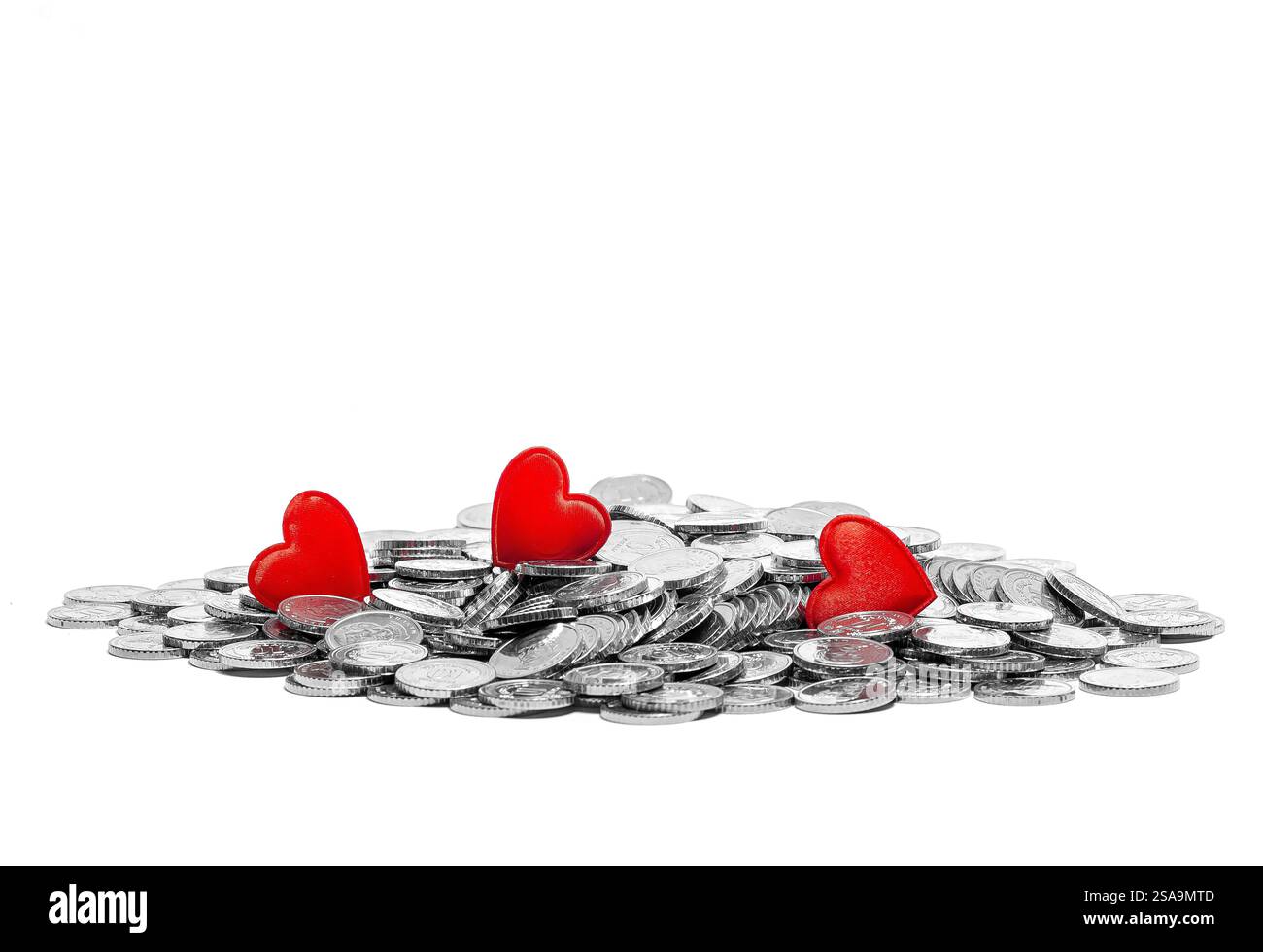 Three red hearts on pile of silver coins, isolated on white. Idea for ...