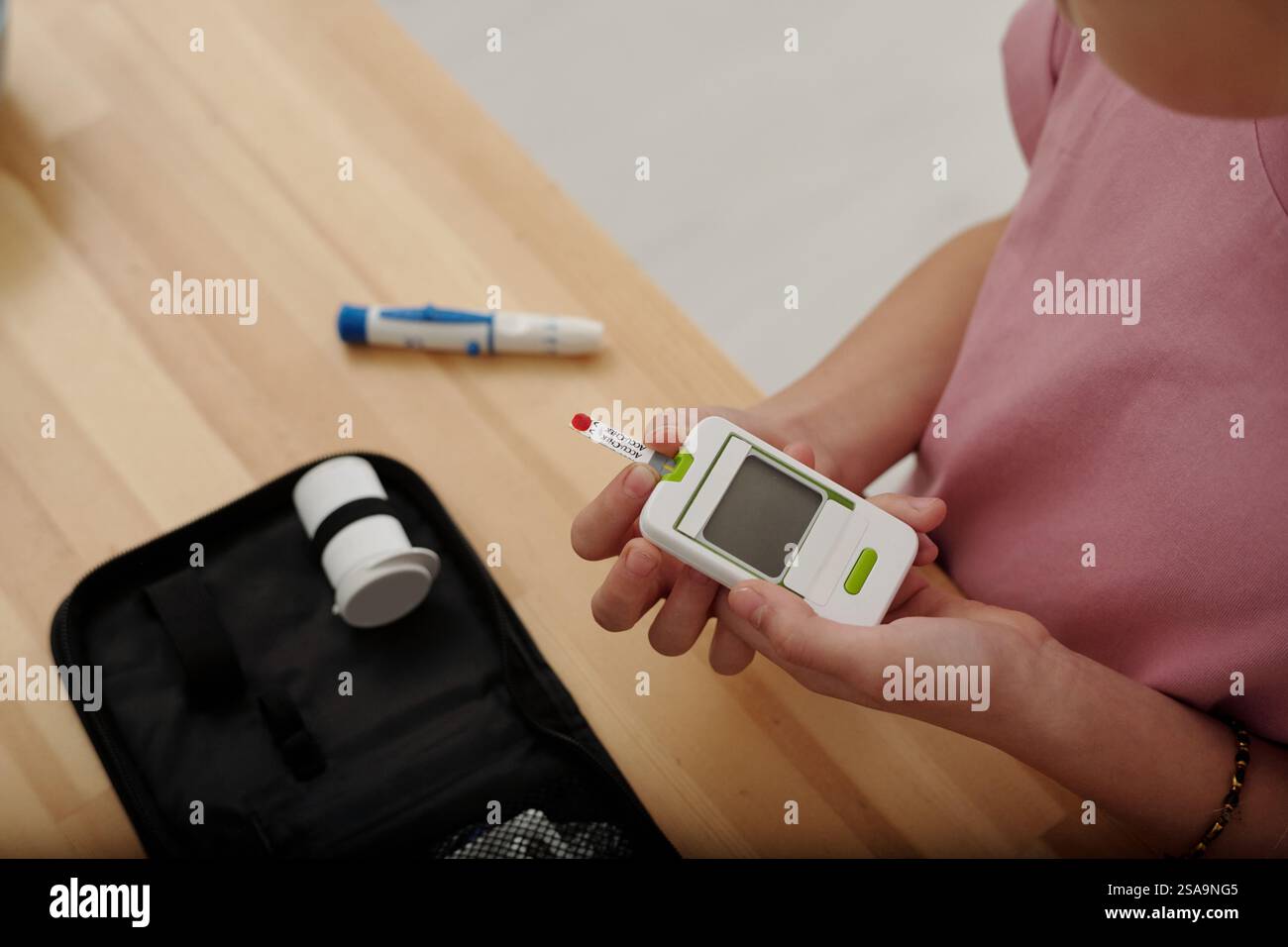 Girl Looking at Glucose Monitor Stock Photo - Alamy