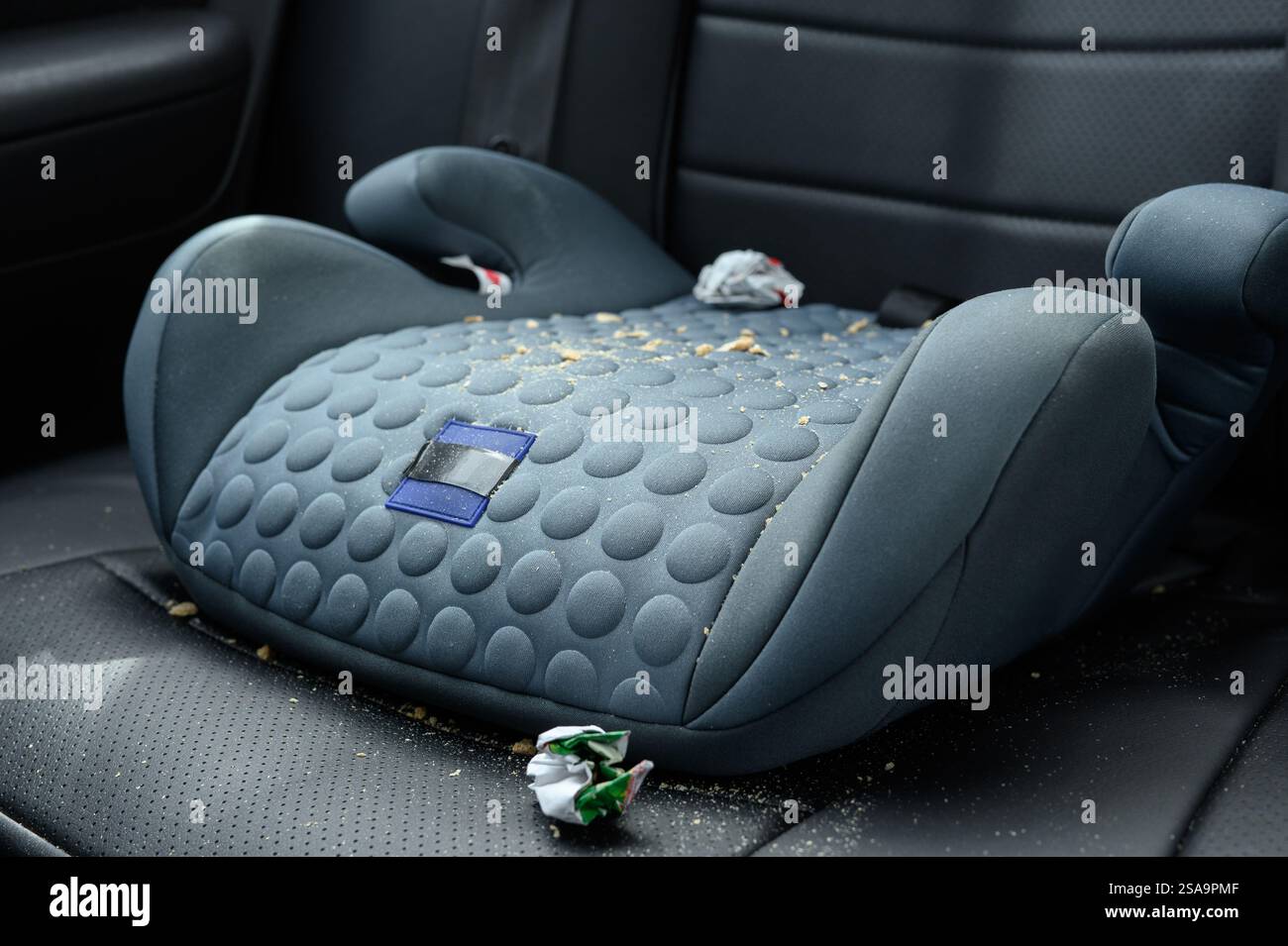 Child car seat, booster, securely fastened to back seat of car ...