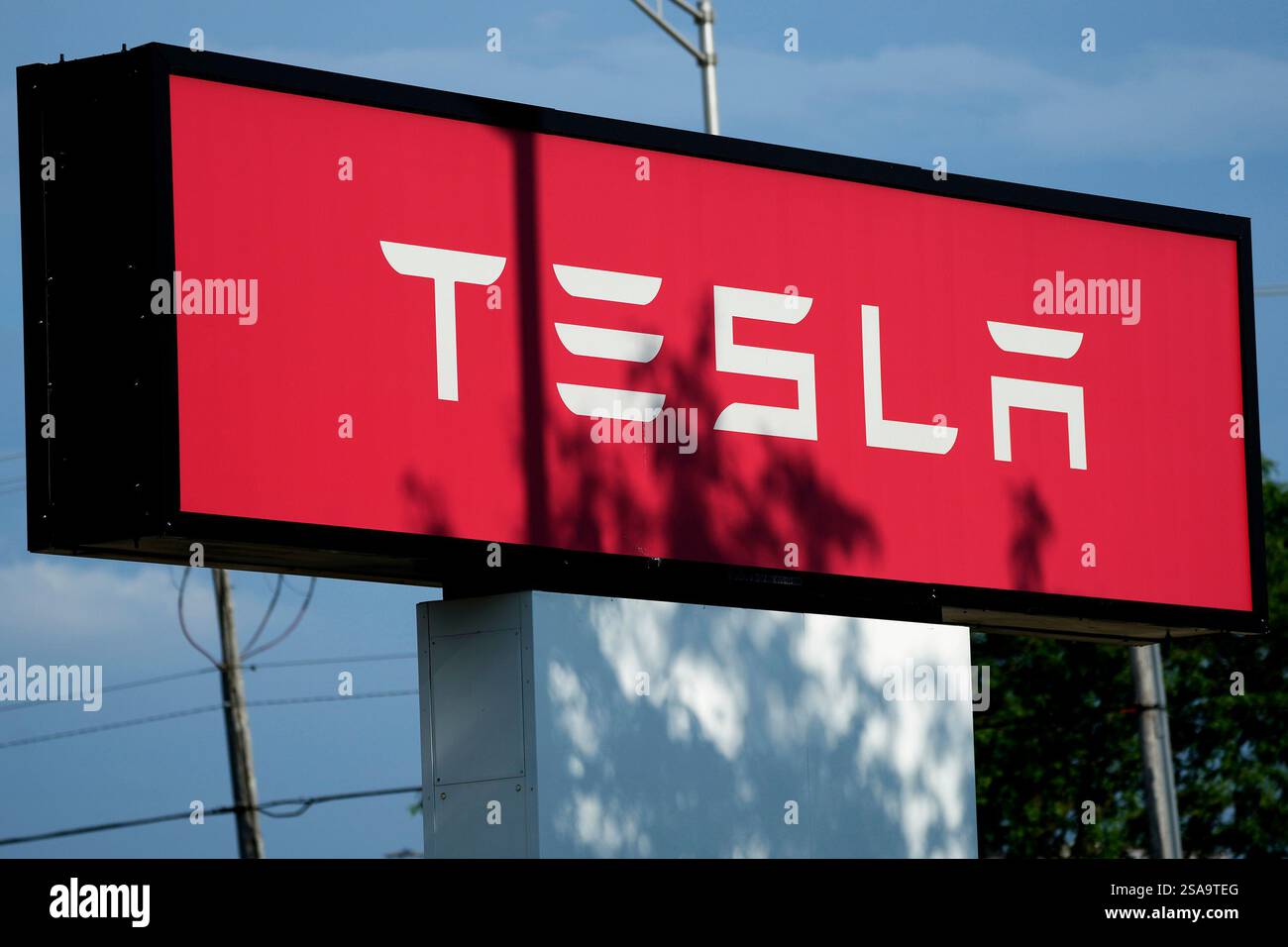 Tesla sign is shown at Tesla dealership in Schaumburg, Ill., Wednesday ...