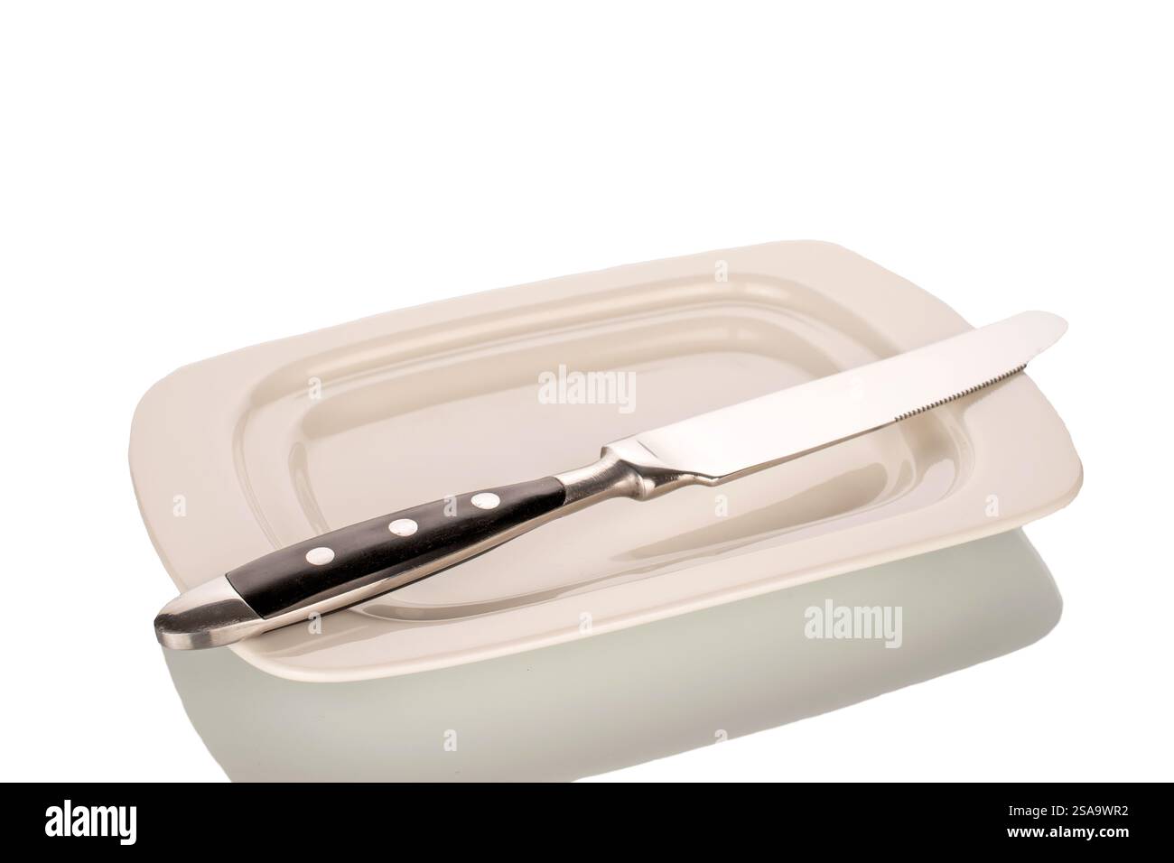 One ceramic butter container with a metal knife, close-up, isolated on ...
