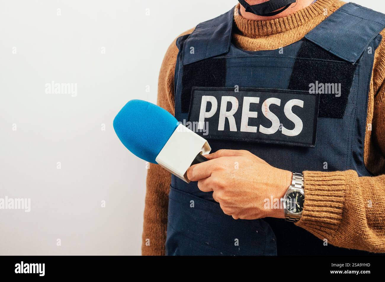 Reporter with bulletproof vest holding a microphone in studio Stock ...