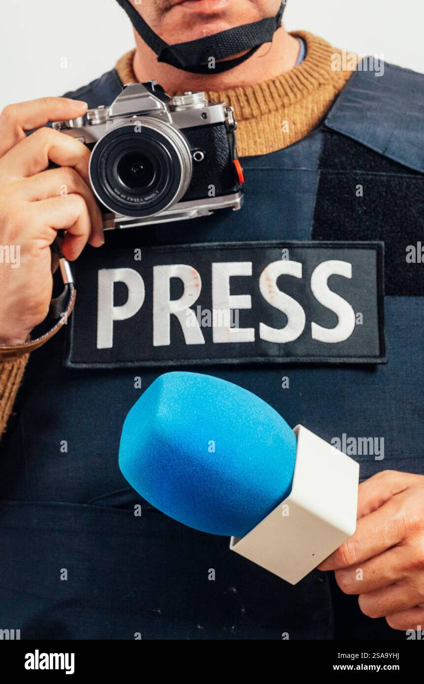 Reporter in bulletproof vest with a camera Stock Photo - Alamy
