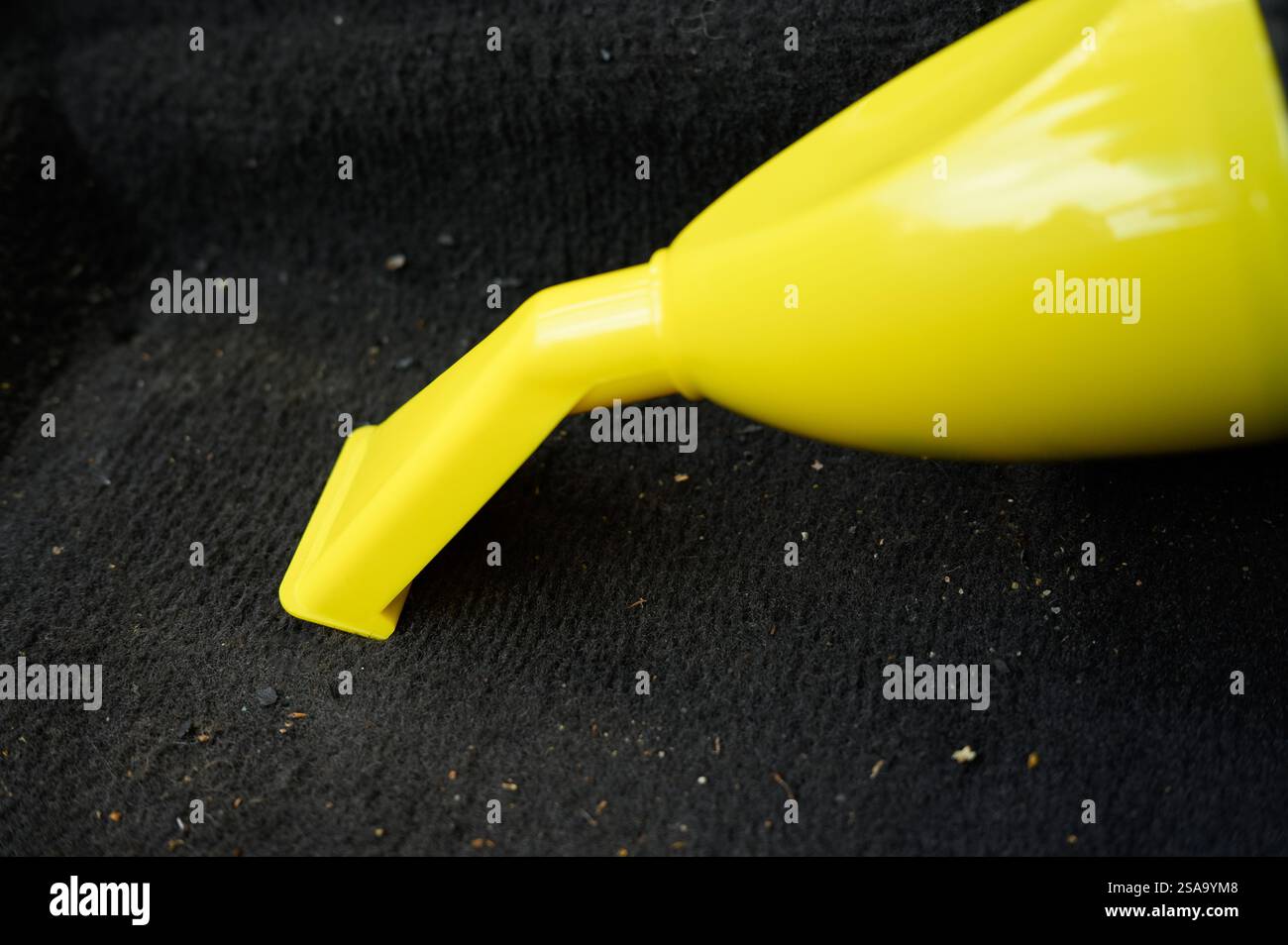 Cleaning the carpet on floor of car from dirt and sand, close-up. Care ...