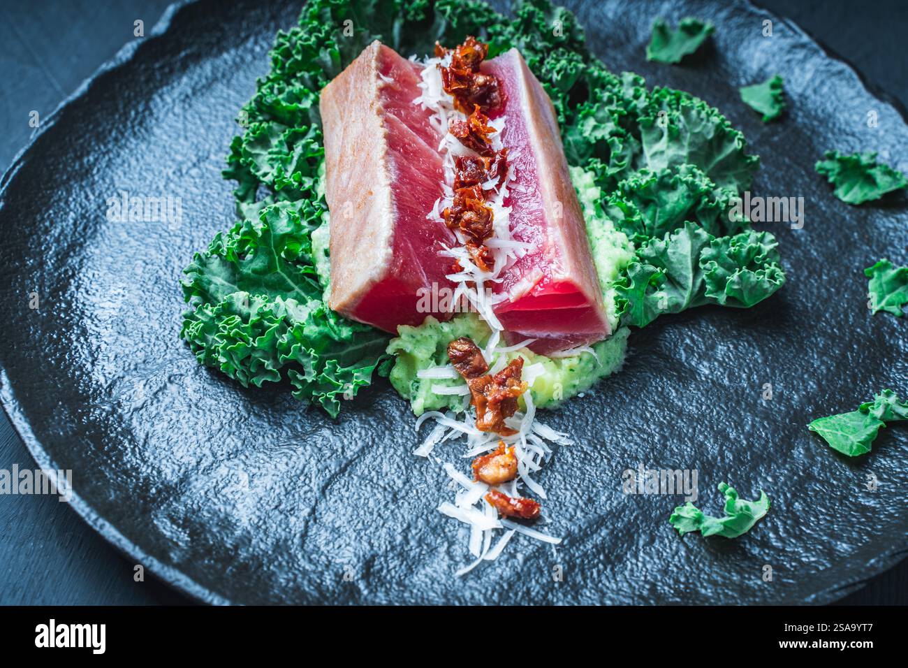 Tuna served with mashed potatoes, kale salad, sun-dried tomatoes and ...