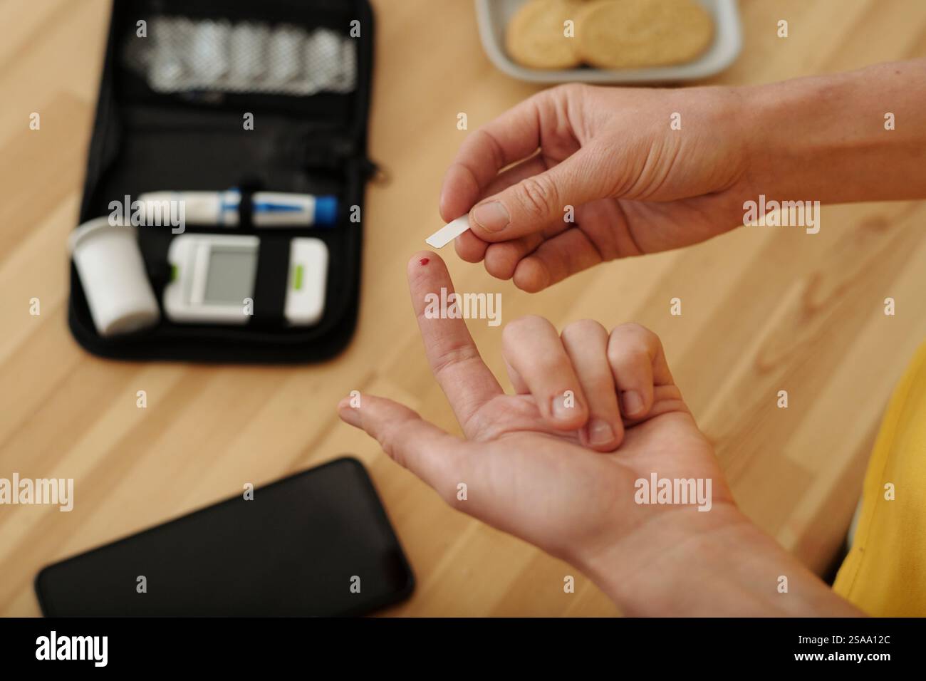 Person using glucose monitoring hi-res stock photography and images - Alamy