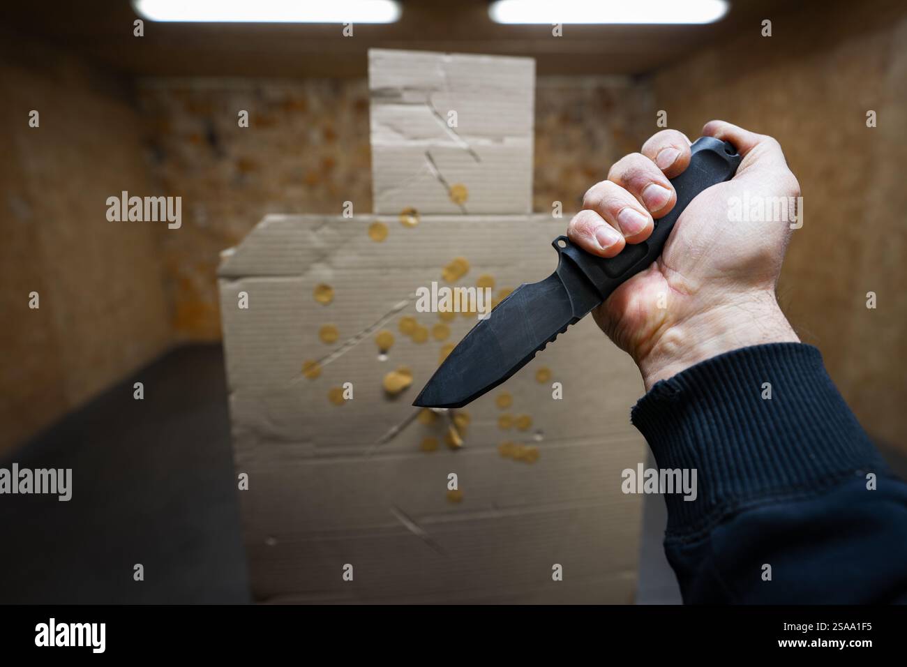 Knife fighting training, first-person view. Knife in a man's hand and a ...