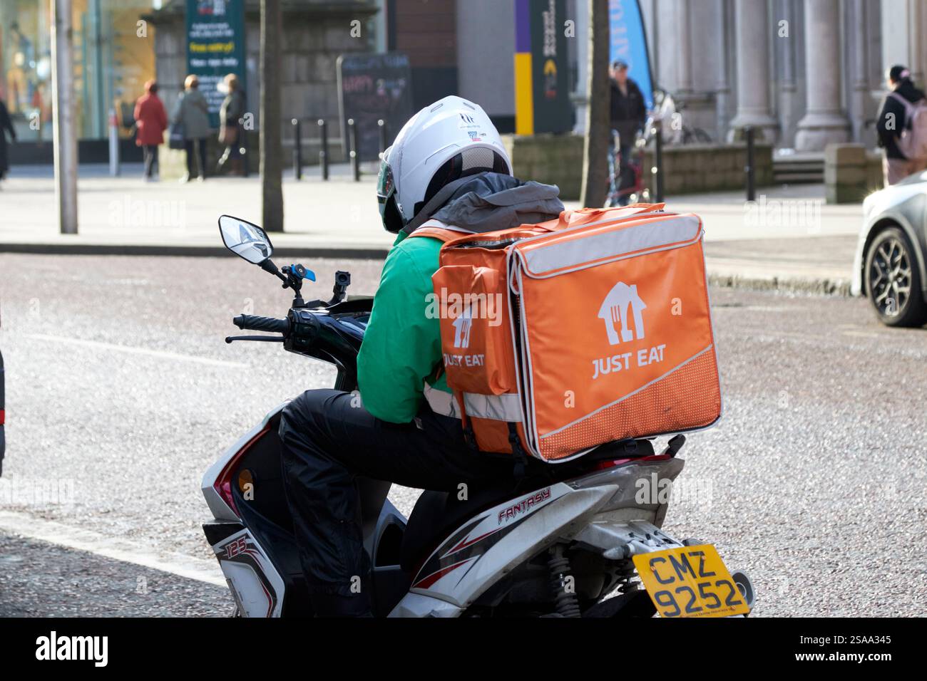 just eat delivery driver sitting on moped in belfast city centre ...