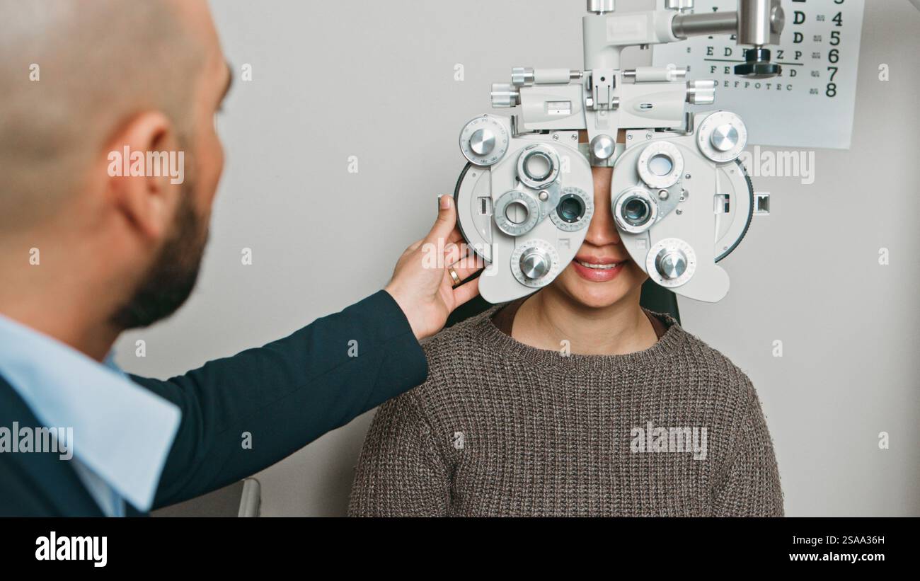 Optometrist Conducting Eye Examination with Patient Using Phoropter ...
