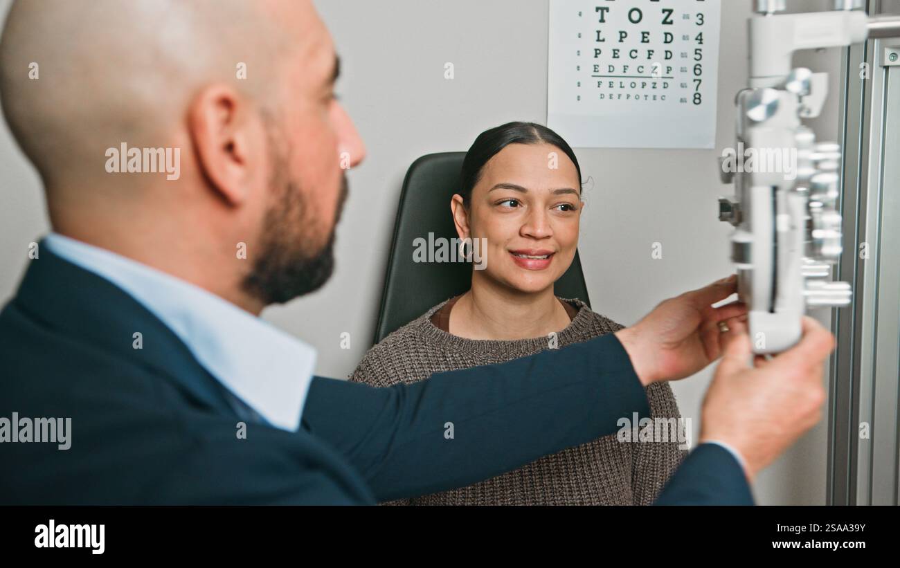 Optometrist Assisting a Patient During an Eye Examination Using ...