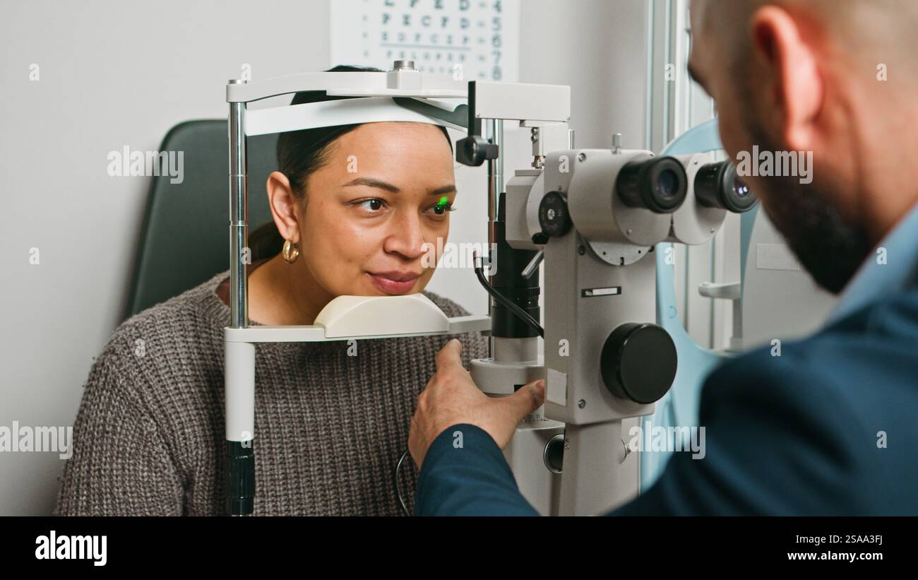 Optometrist Conducting Eye Exam for Patient Using Medical Equipment ...