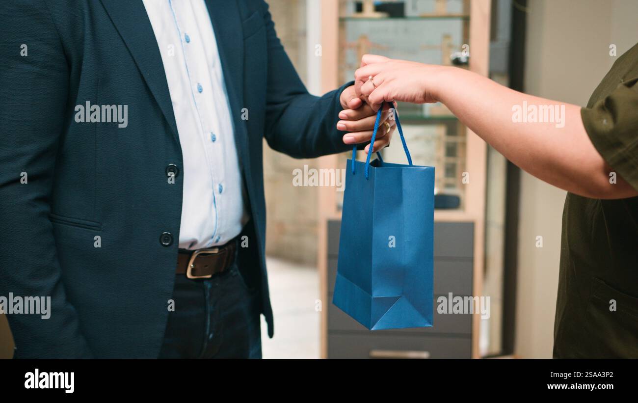 Business Interaction Featuring a Professional Handing Over a Shopping ...