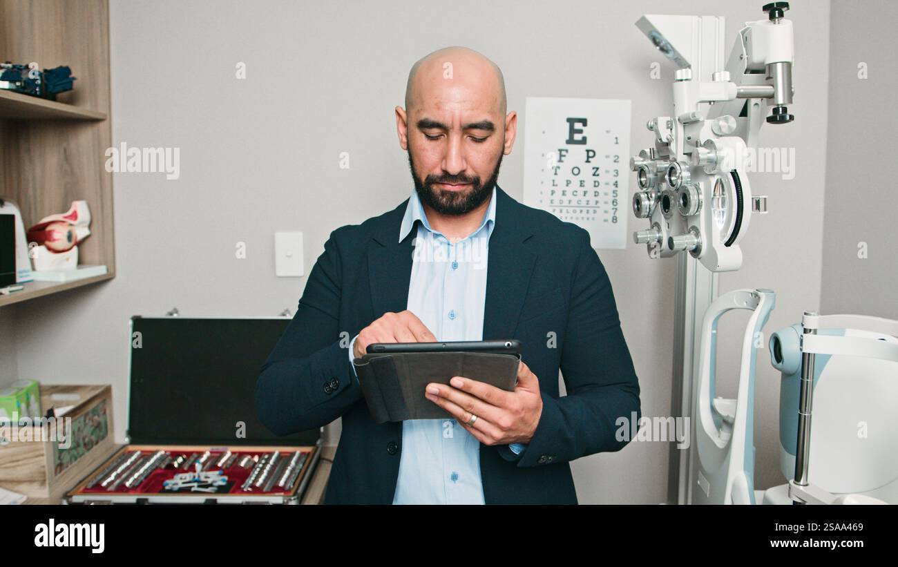 Professional Optometrist Using Tablet in Modern Office with Medical ...