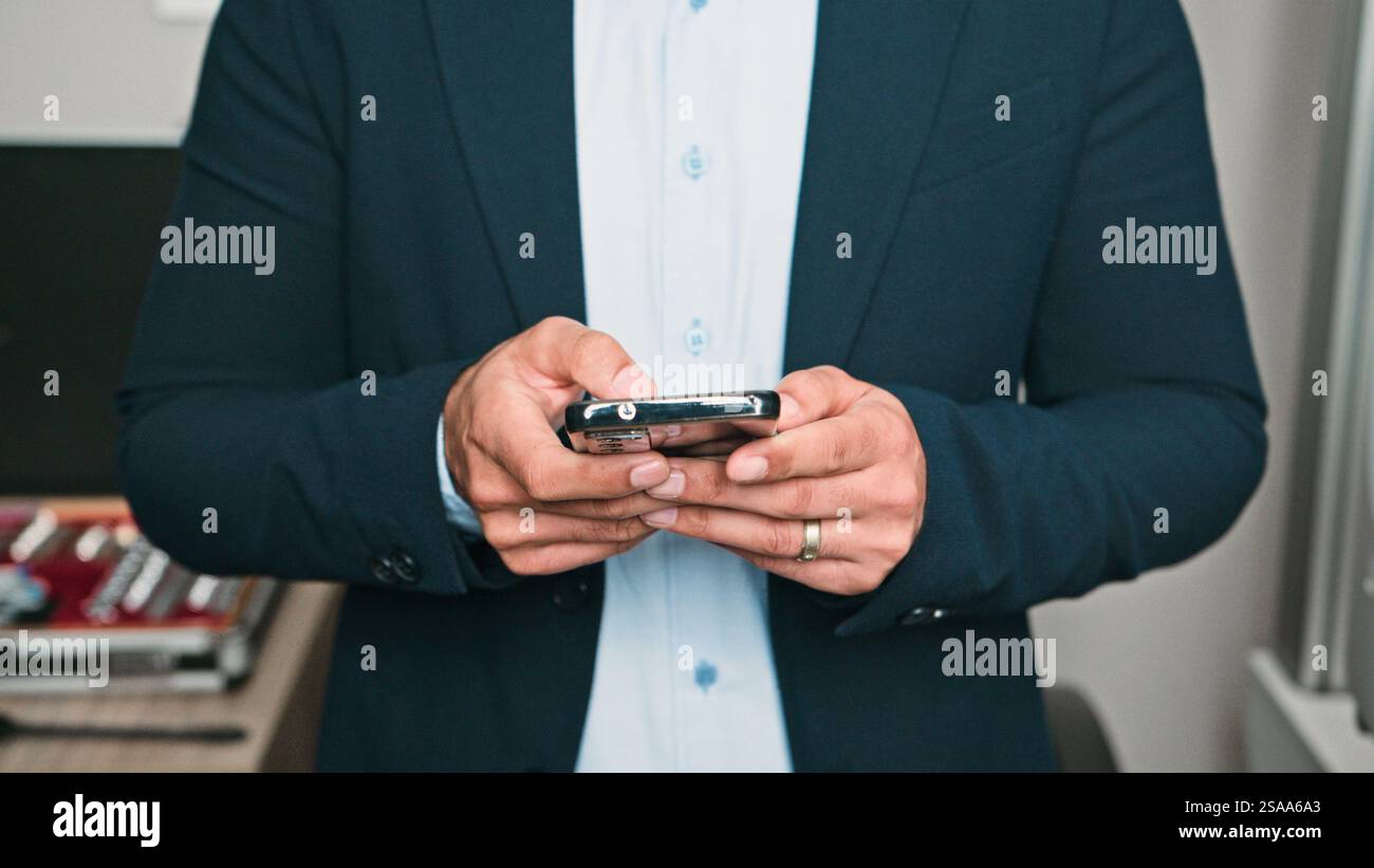 Business Professional Communicating Using a Smartphone in an Office ...