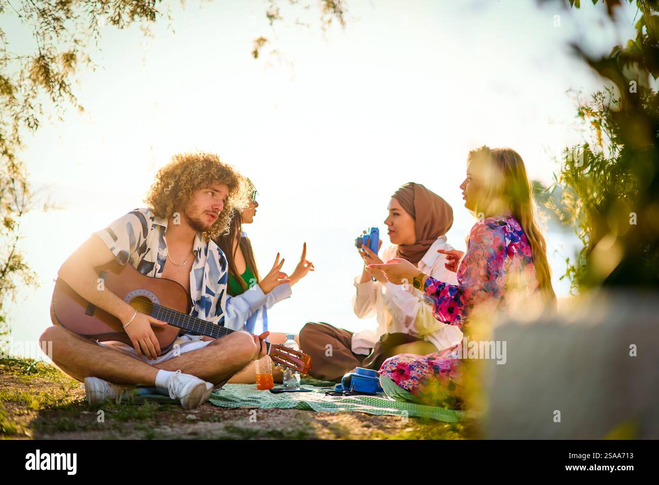 A group of friends gather on the beach sharing joyful moments filled ...