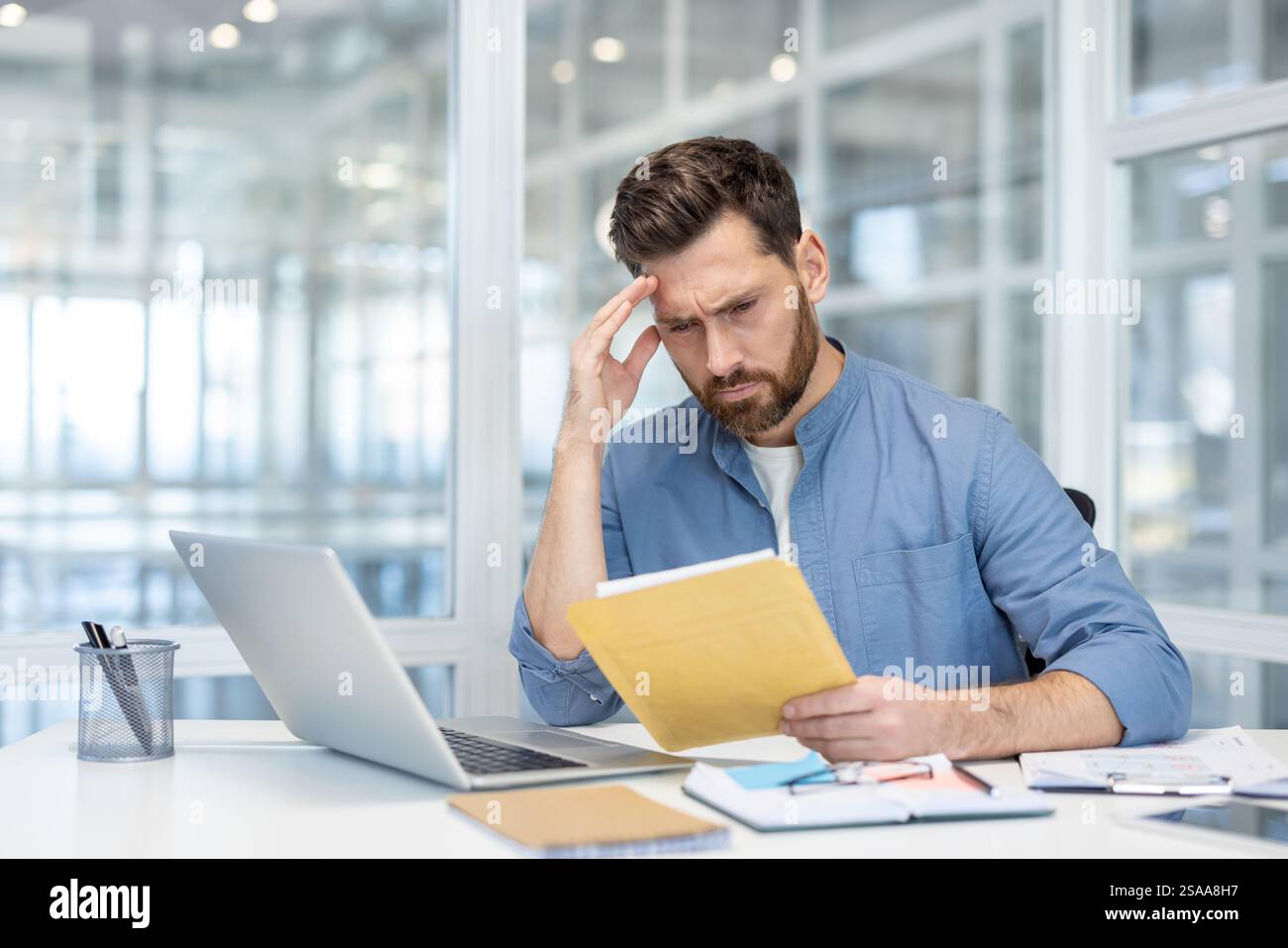 Bad news mail message about bankruptcy. Man upset inside office ...