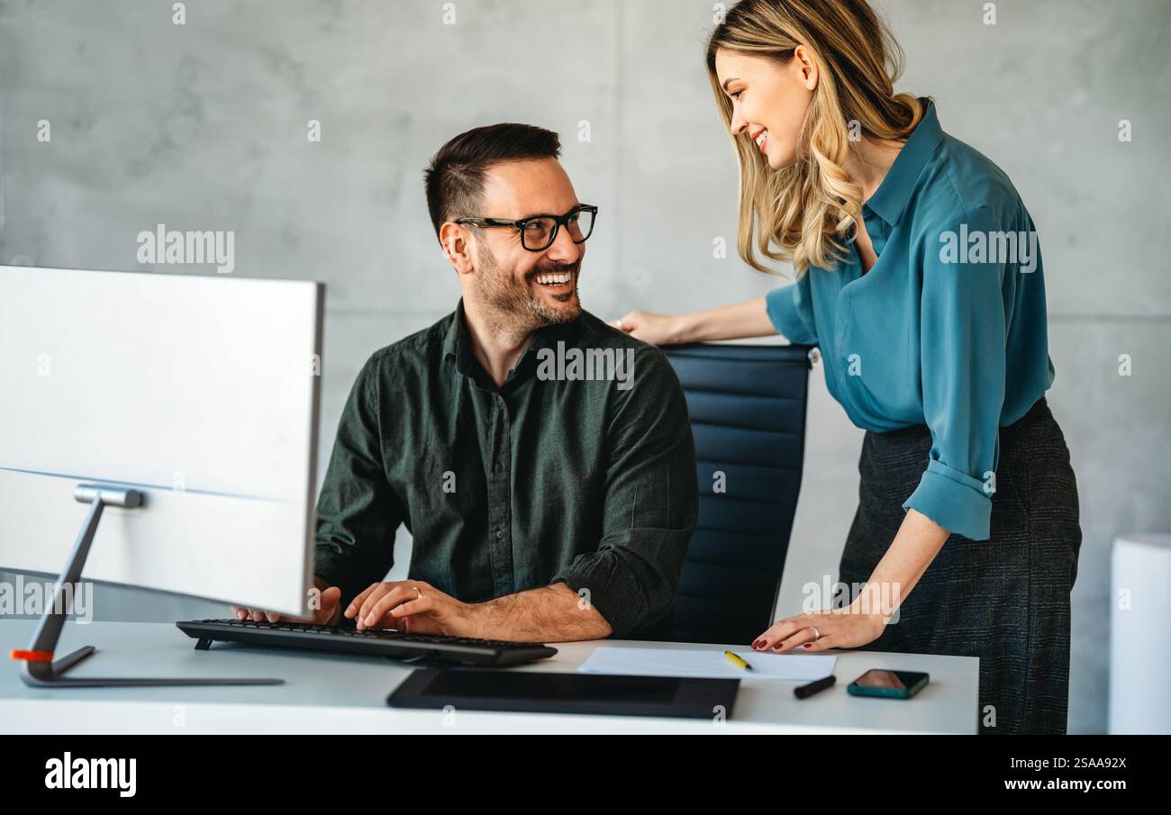 Happy businesspeople laughing while collaborating on a new project in an office Stock Photo - Alamy