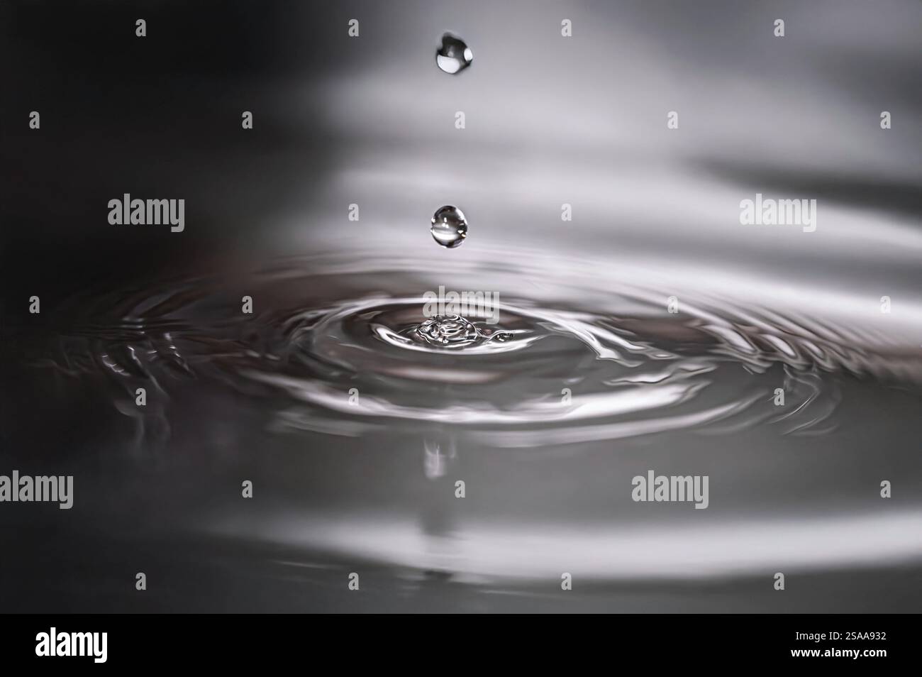 Water drop on water surface. Splash effect after collision a falling ...