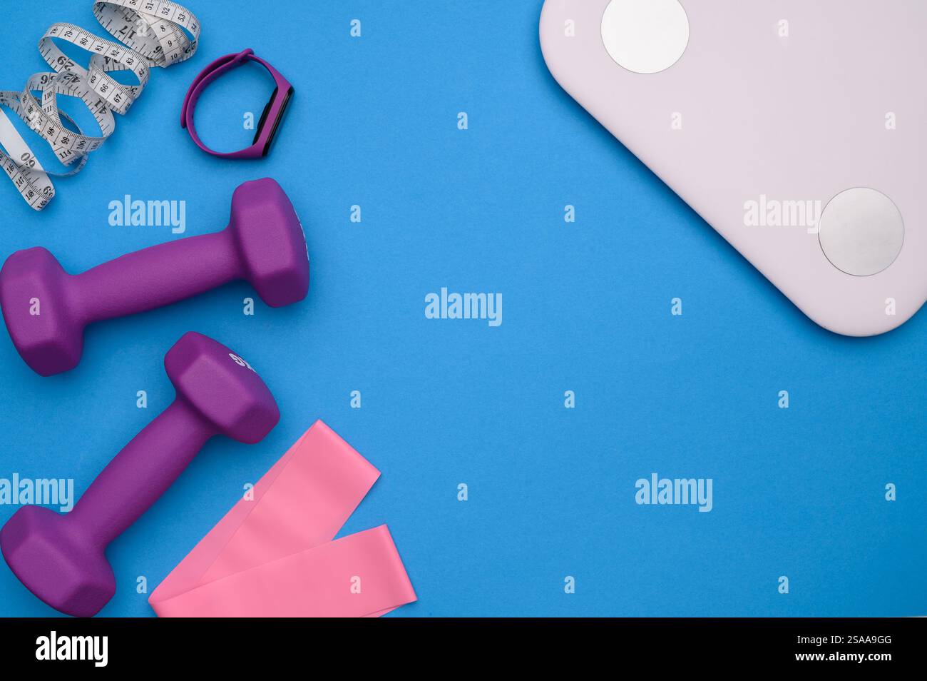 Fitness layout: two purple dumbbells, measuring tape, fitness bracelet ...