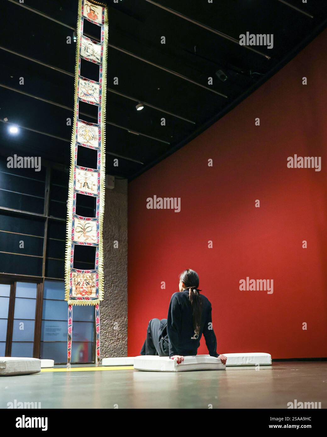 London, UK. 29th Jan, 2025. Exhibition staff with 'Epilogue', 2024. 'Citra Sasmita: Into Eternal ...