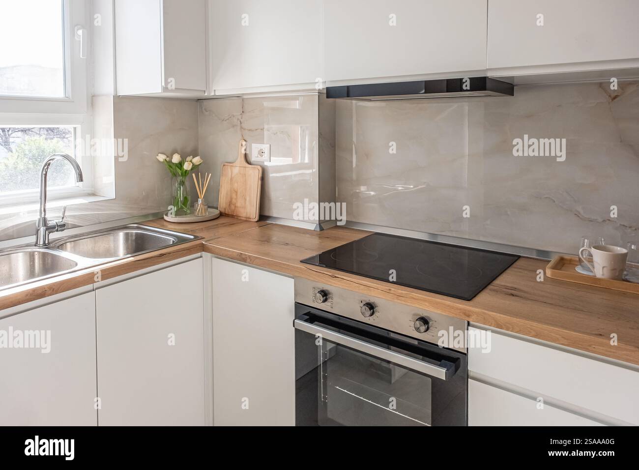 A kitchen interior with wooden countertop and cooking stove. Counter ...