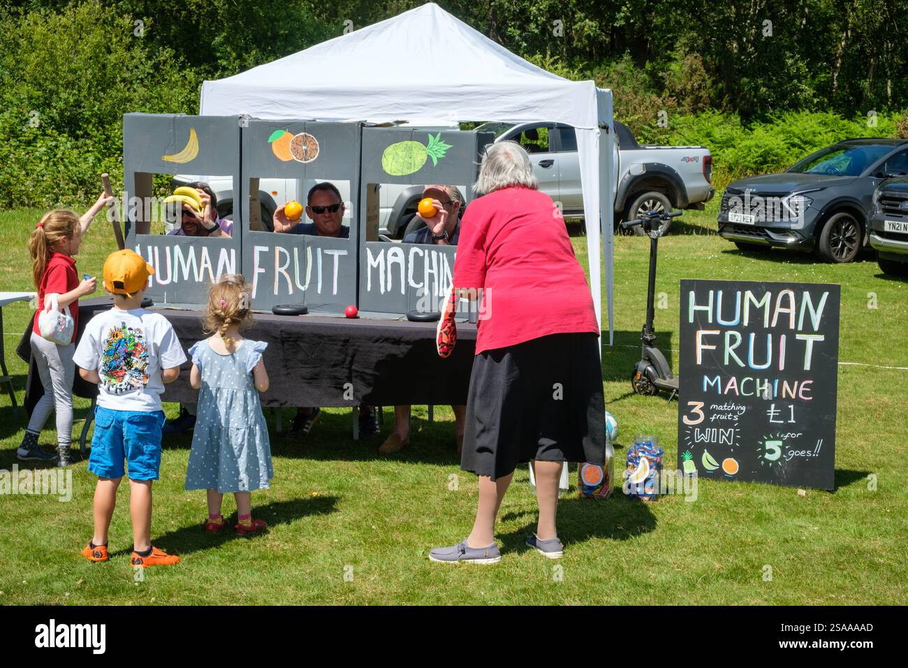 A Human Fruit Machine game at a village Fete Stock Photo - Alamy