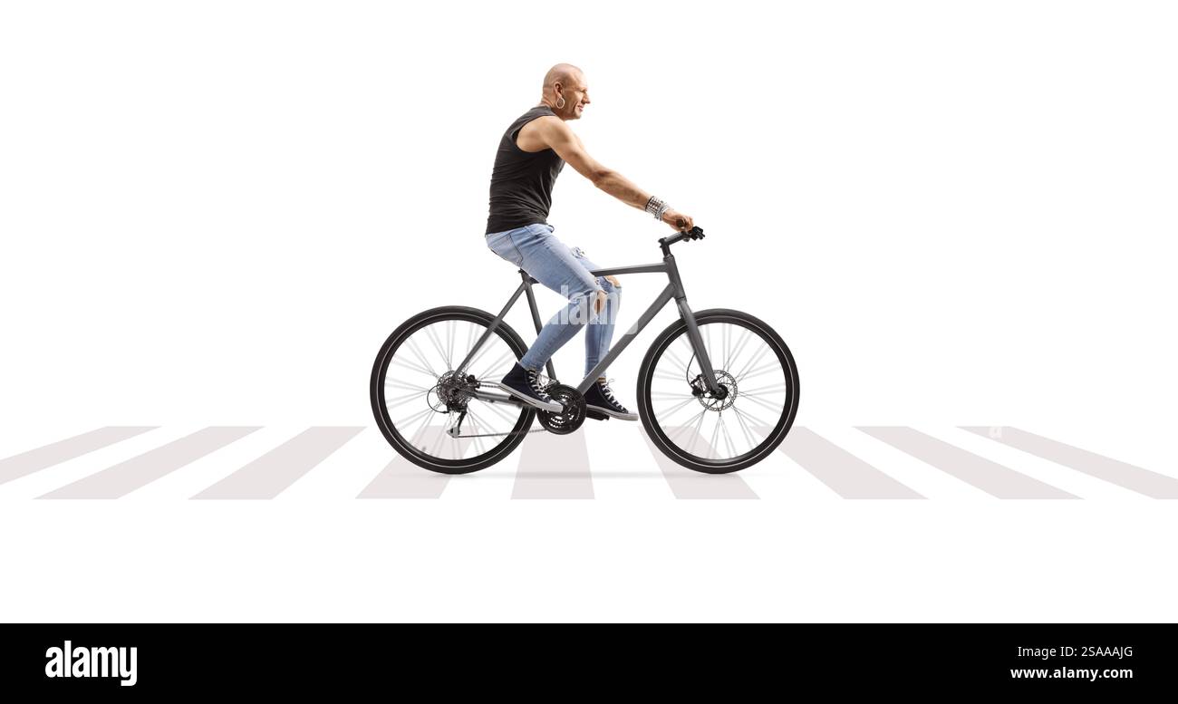 Full length profile shot of a guy riding a bicycle at a pedestrian ...