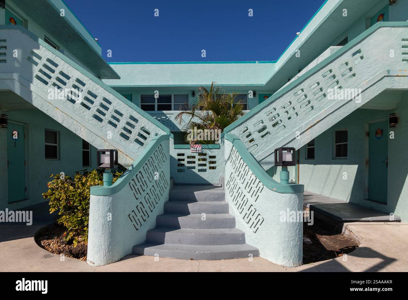 Vintage pastel-colored motel with retro architectural details in ...